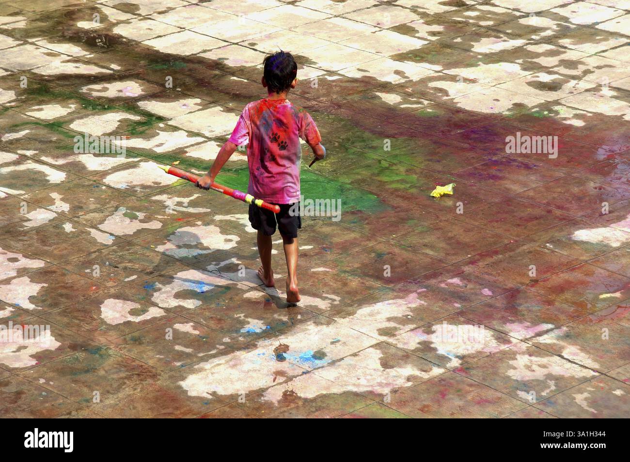 One boy child playing Holi festival of color at Ananta apartments at ...