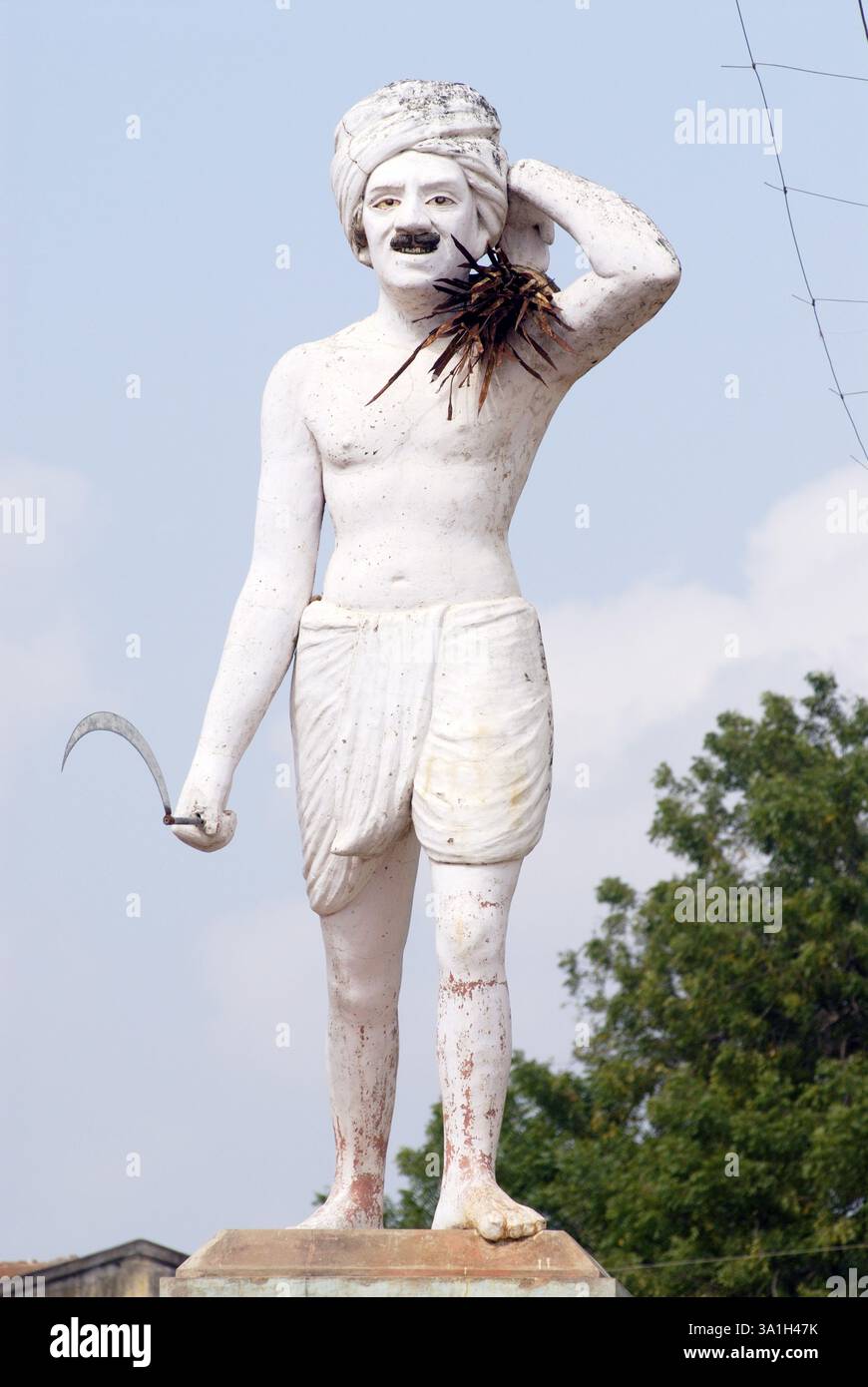 Huge statue of farmer with sickle in one hand and crop in other at ...