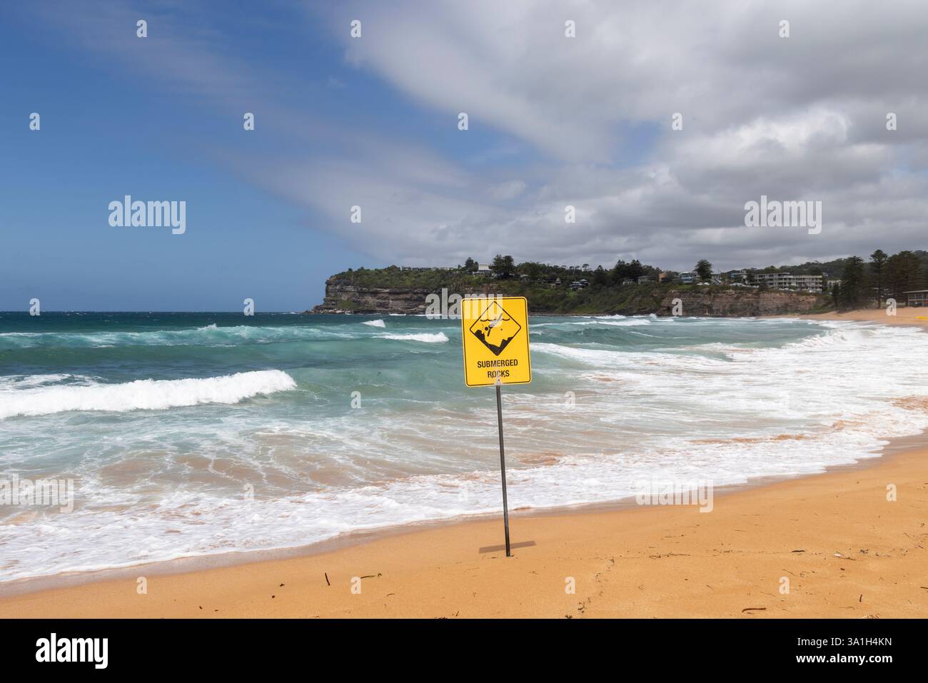 Danger submerged rocks sign on Avalon Beach in Sydney, warning swimmers ...