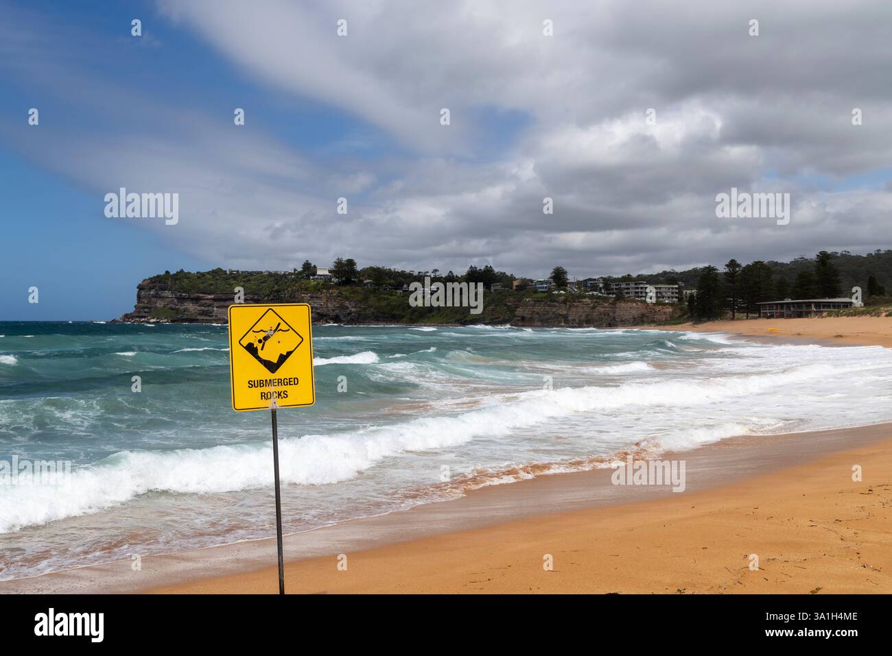 Danger submerged rocks sign on Avalon Beach in Sydney, warning swimmers ...