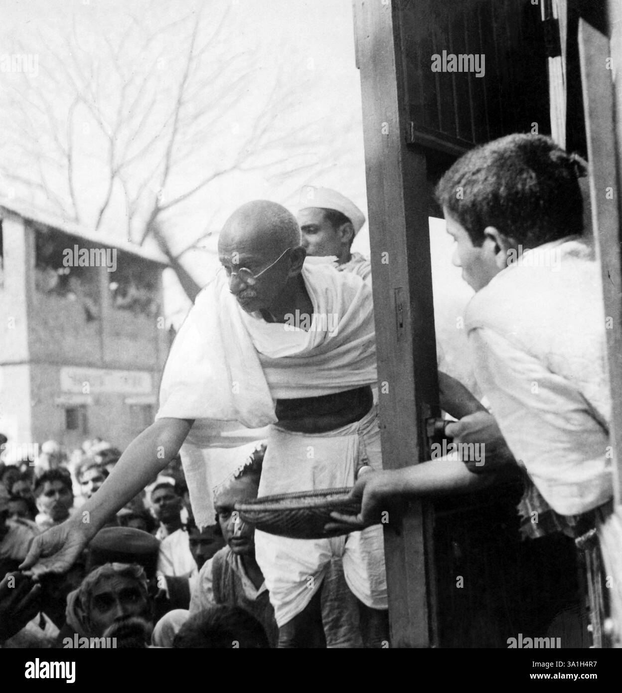 Mahatma Gandhi, collecting donations for Harijan Fund with a basket in ...