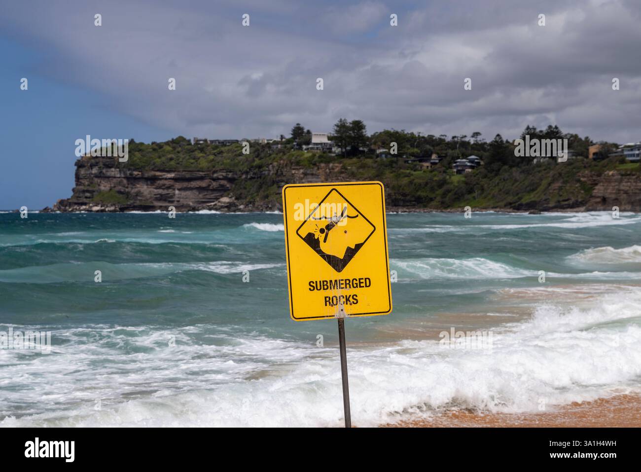 Danger submerged rocks sign on Avalon Beach in Sydney, warning swimmers ...