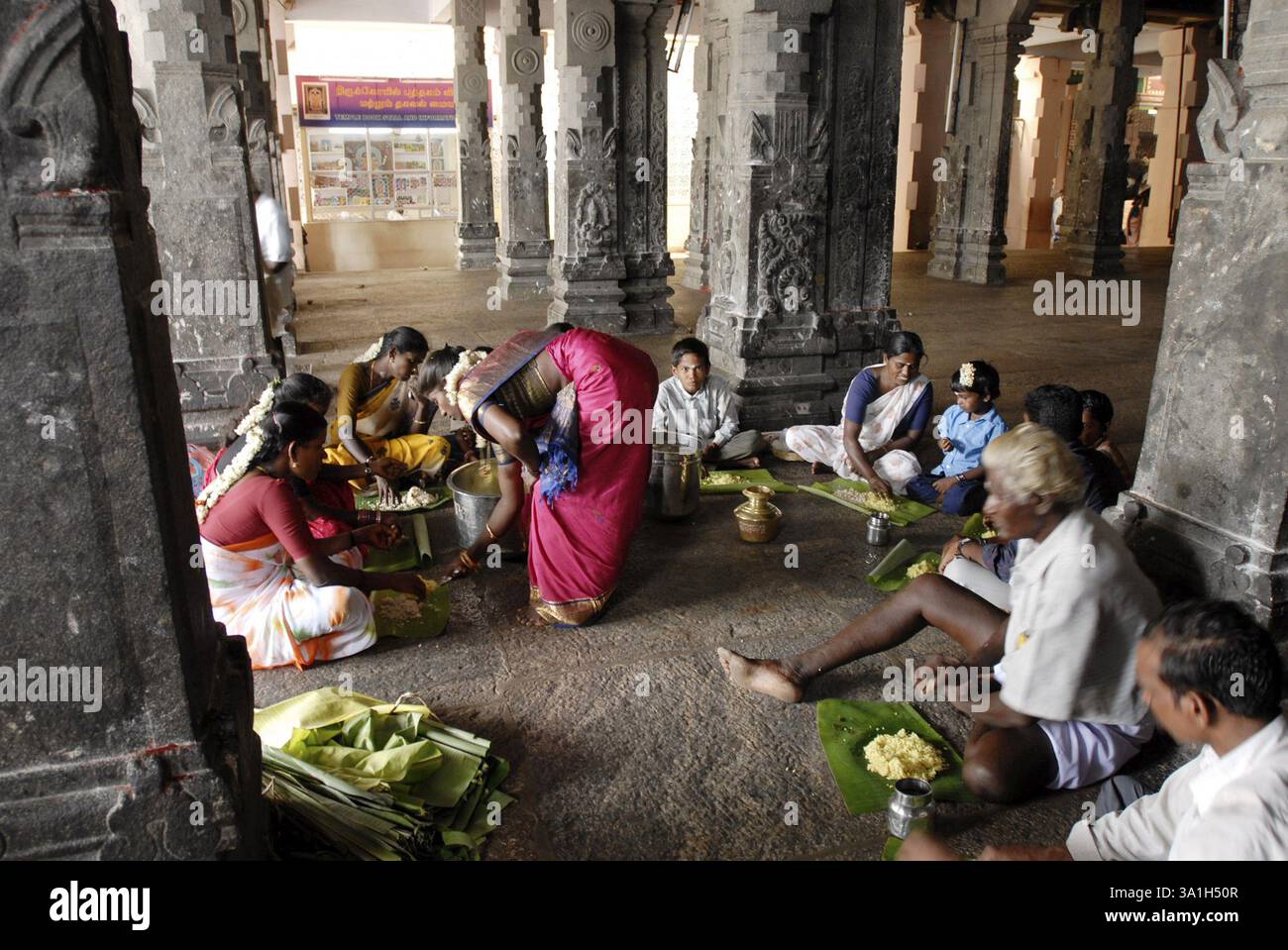 Devotees taking food in temple Urchava mandap of Meenakshi ...