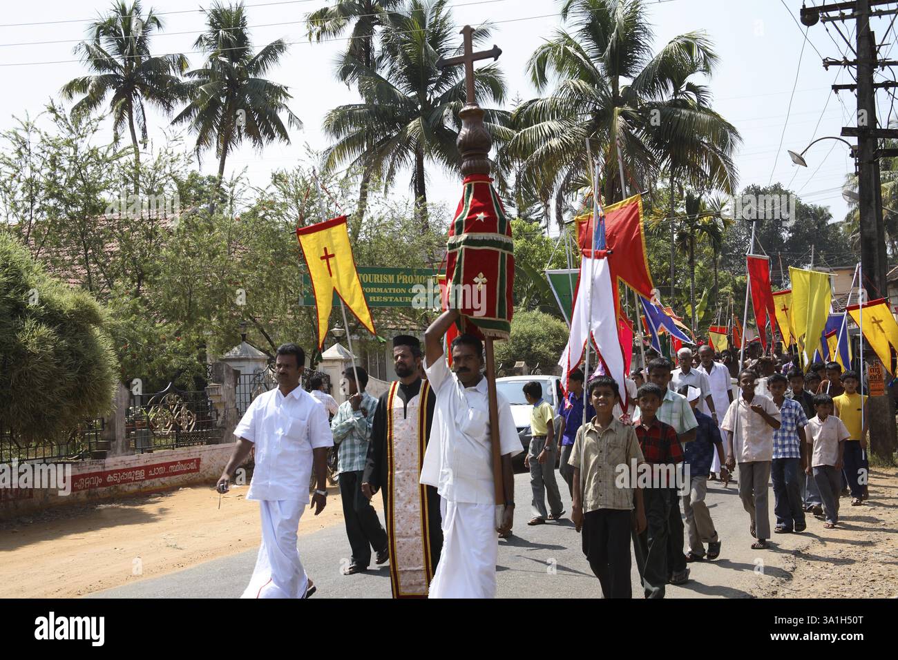Syrian Christian starting of procession man with main cross priest and ...