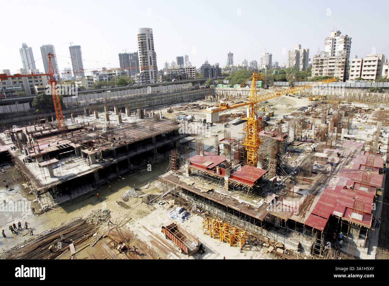 Workers working on the site of buildings being constructed on the site ...
