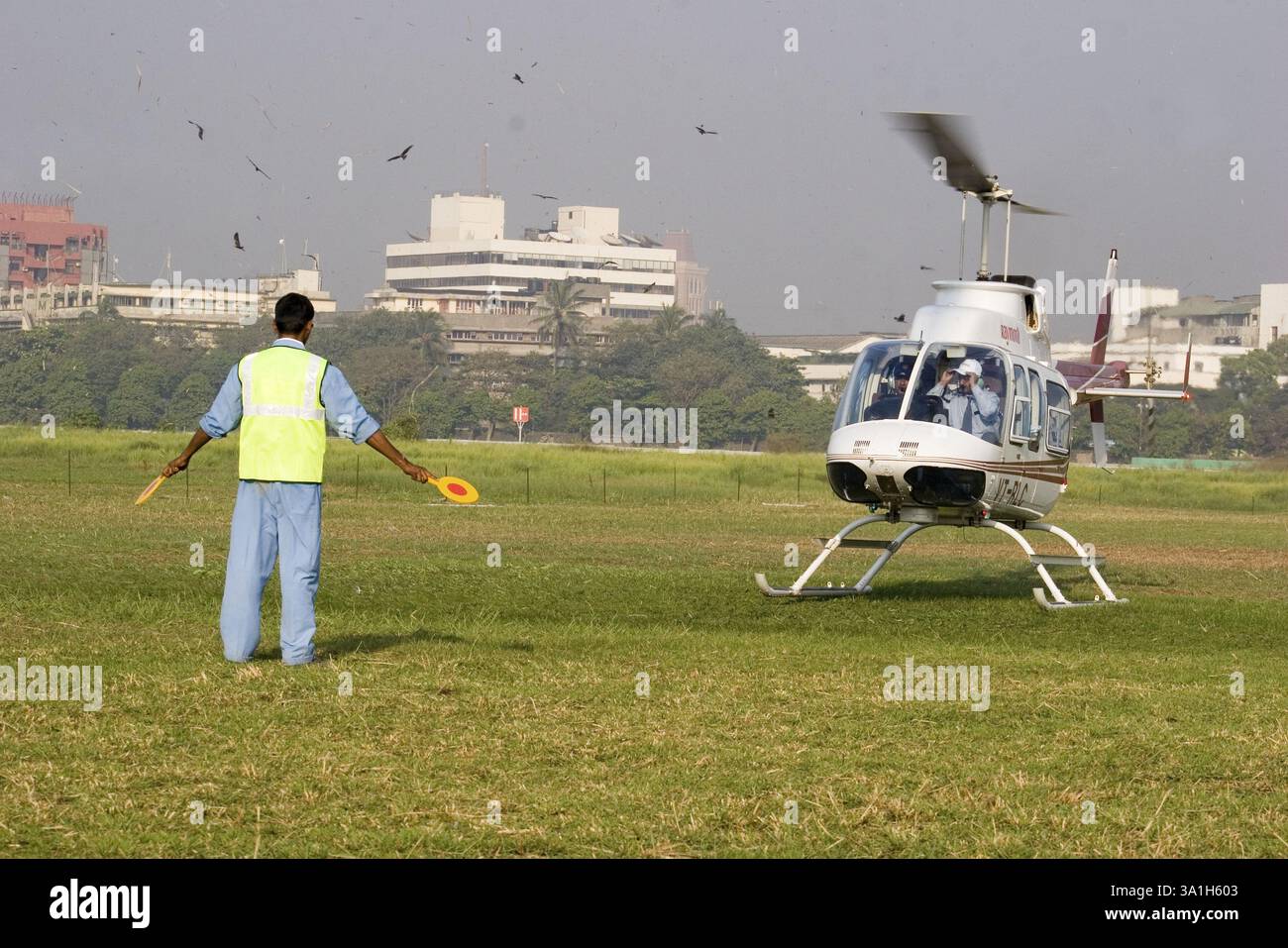 Air transport, man giving direction for landing Helicopter Stock Photo ...