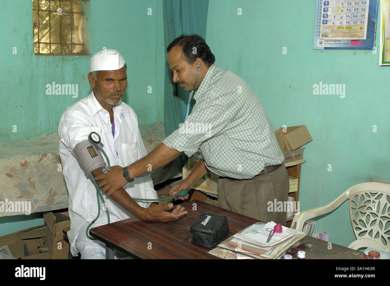Doctor examining villagers at private clinic at Ralegan Siddhi near ...