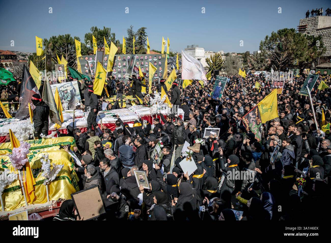 Aitaroun, Lebanon. 1st Mar, 2025. Mourners gather as dozens of coffins ...