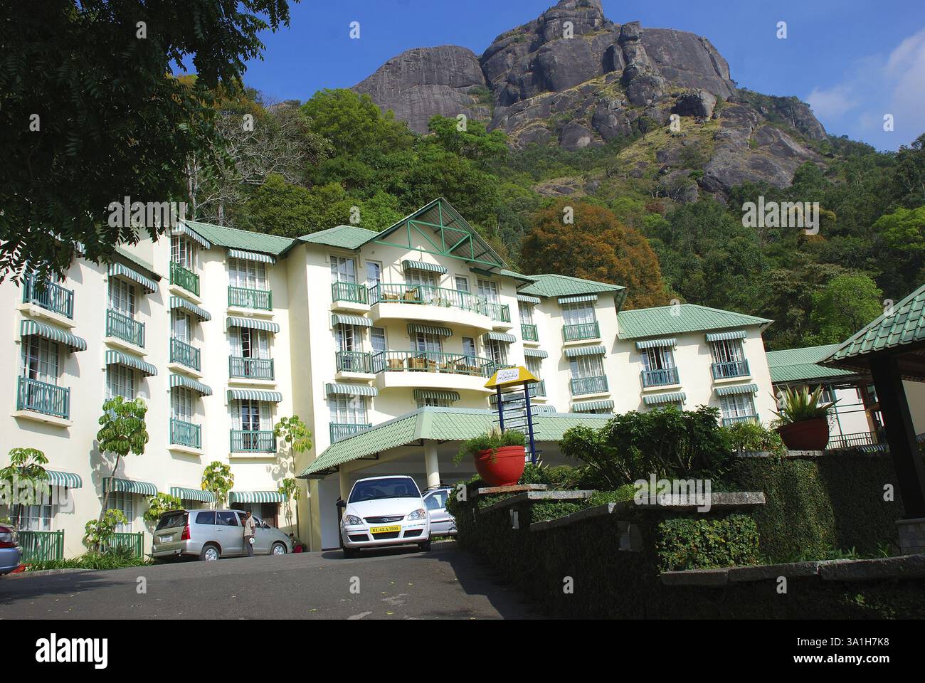 Bungalow type house and hill in background Stock Photo - Alamy