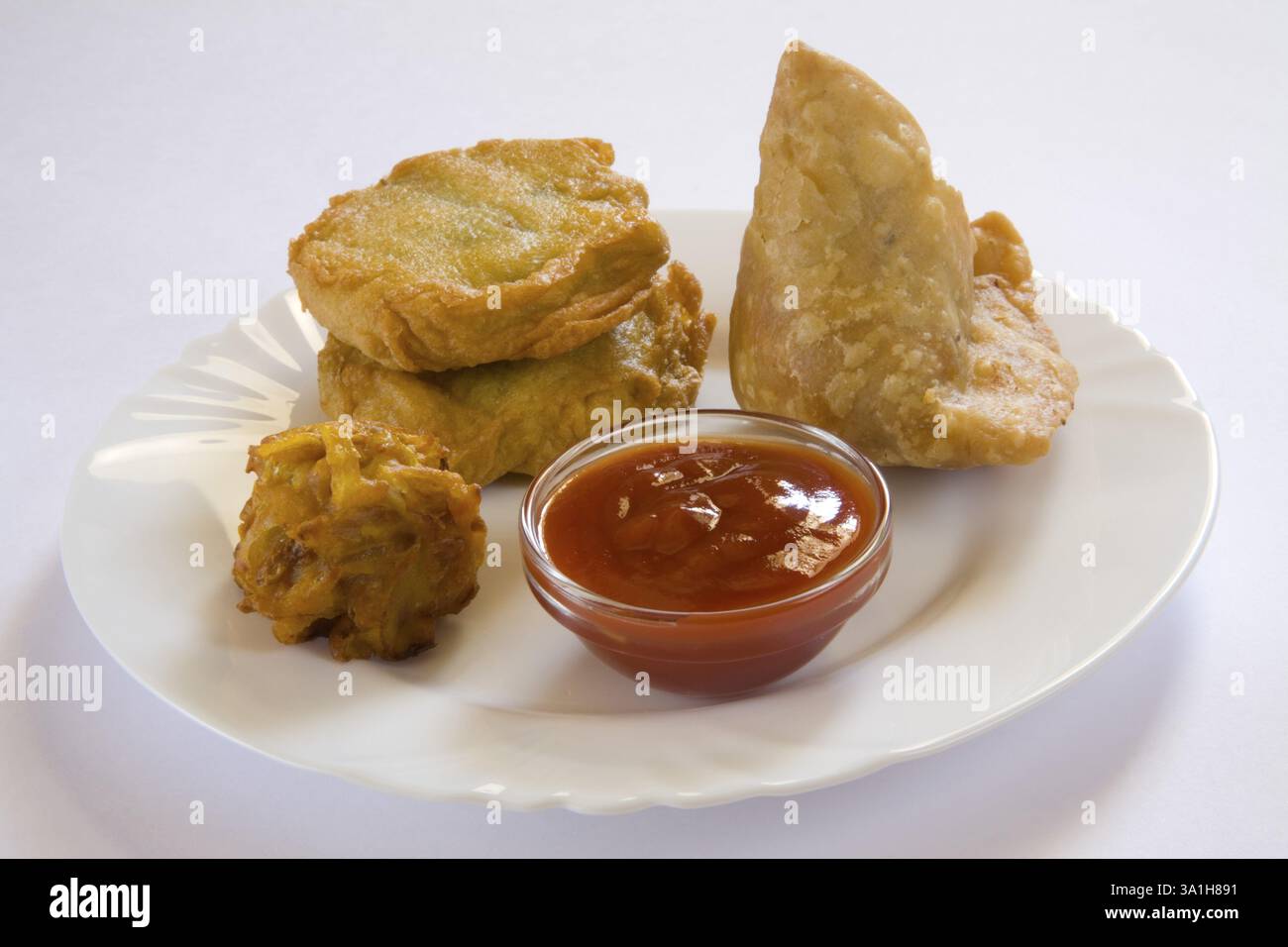 Indian fast food fried batata or potatoes vada kanda bhaji and samosa ...