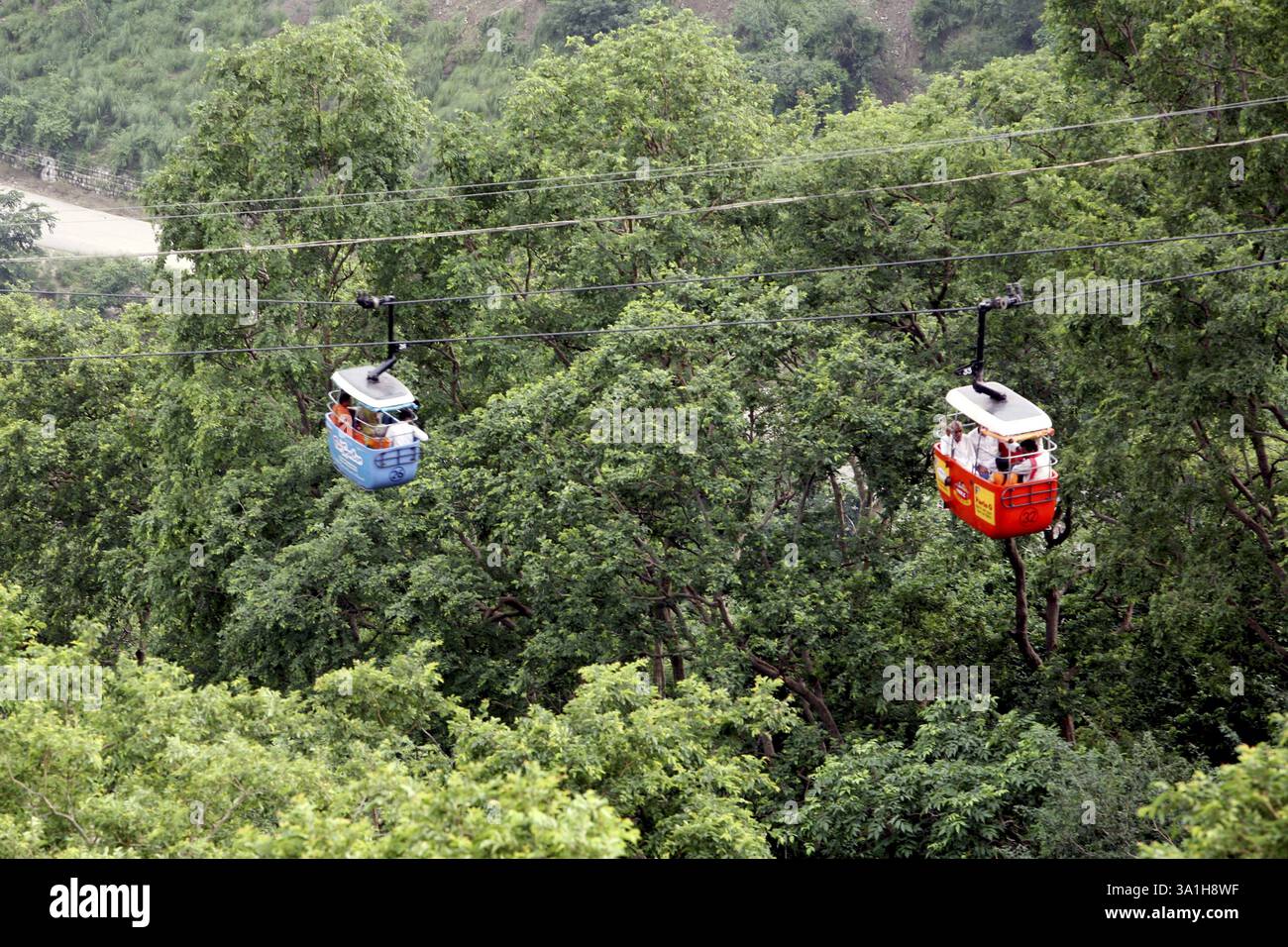 Rope ways trolleys taking devotees to the temple of Mansa Devi located on top of a hill called ...