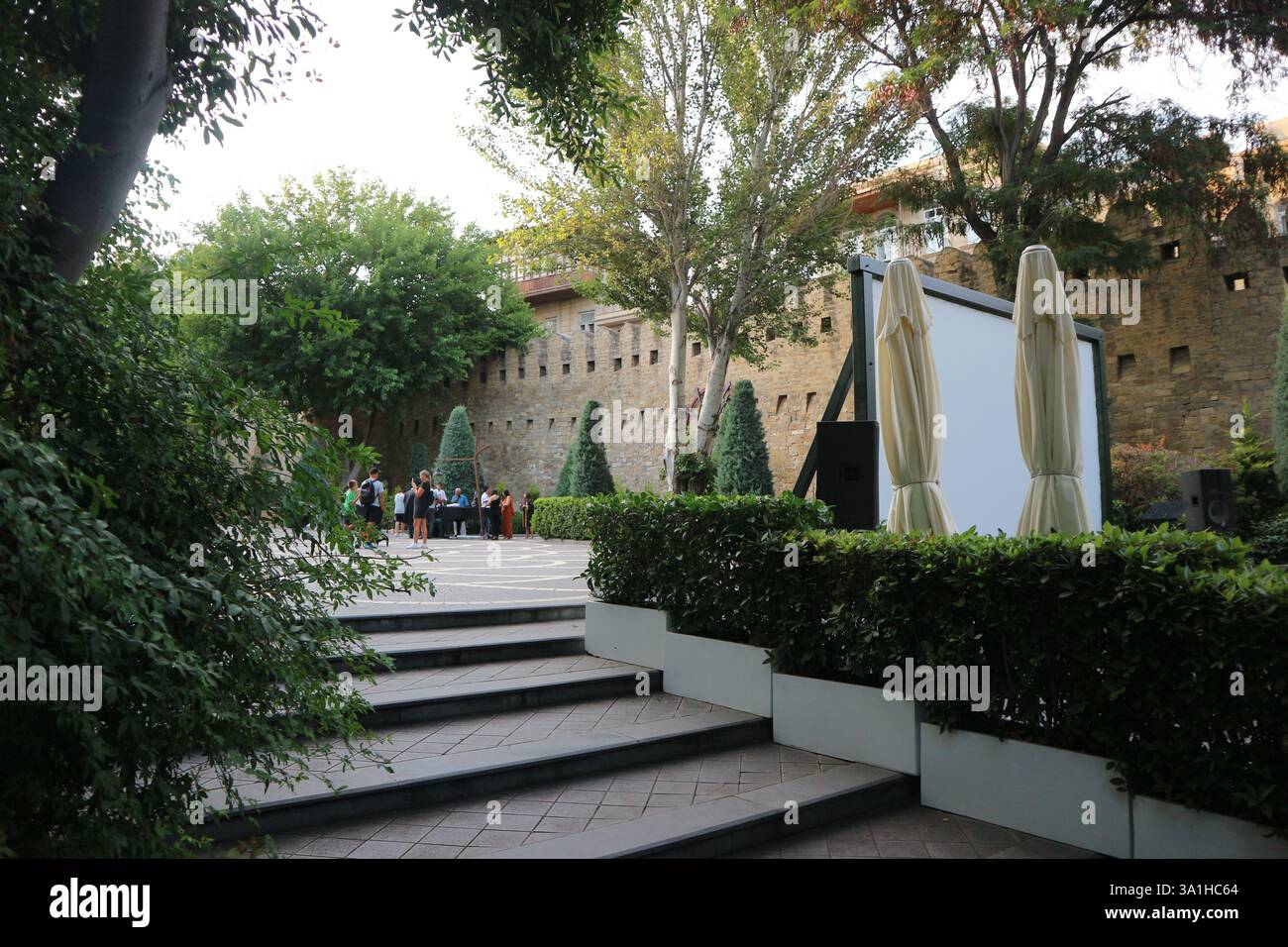 Serene waterfront walkway leading to an iconic architectural ...