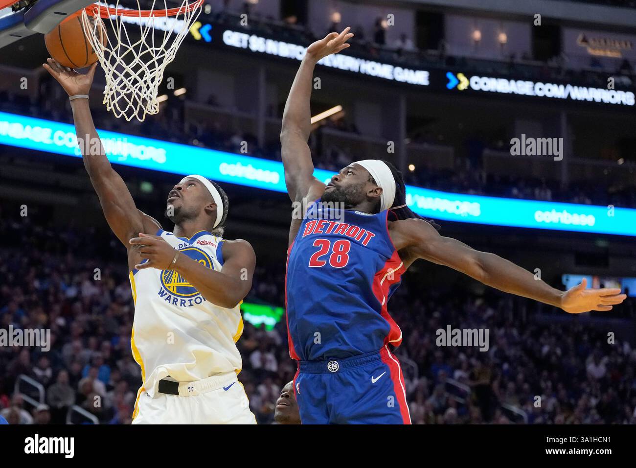 Golden State Warriors forward Jimmy Butler III, left, scores against ...
