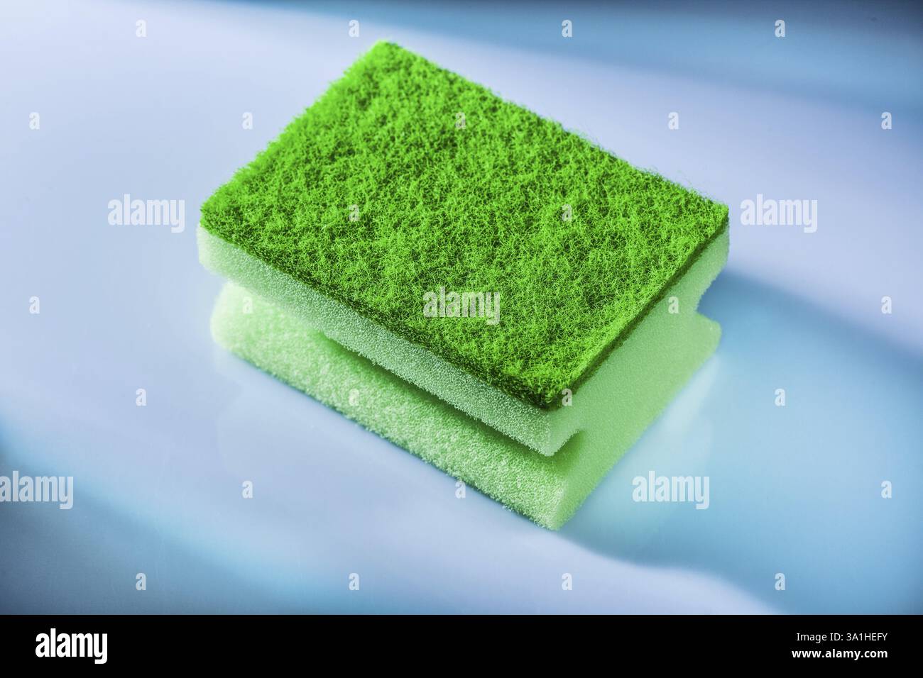 Green sponge on white background Stock Photo - Alamy