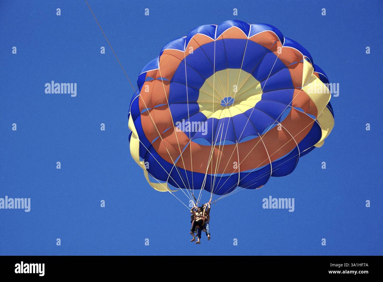 Up in sky, Parasailing, tourists with colorful parachute on Colva beach ...