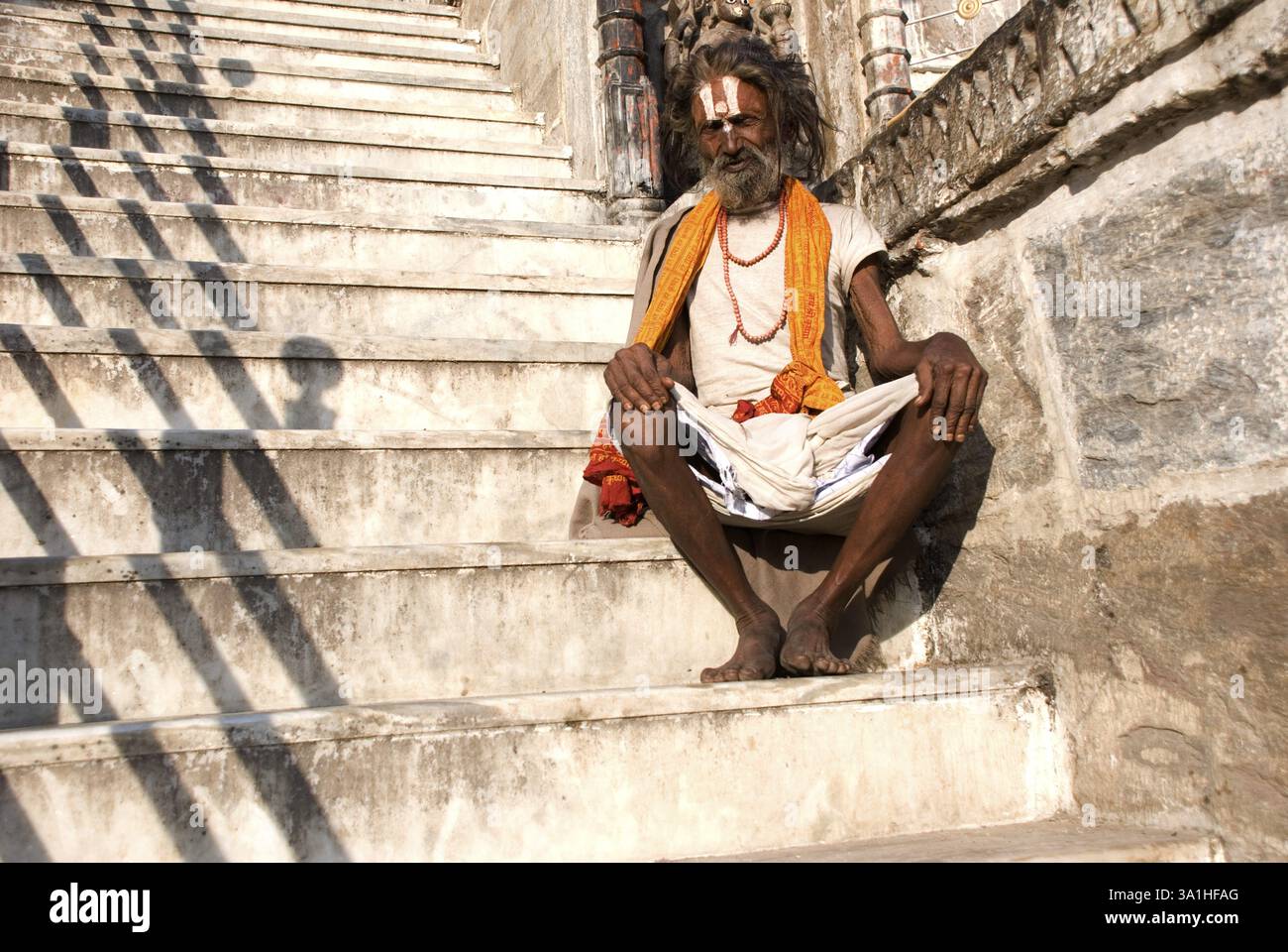 Hindu pundit sitting on staircase of Shree Jagannath Raiji's temple at ...