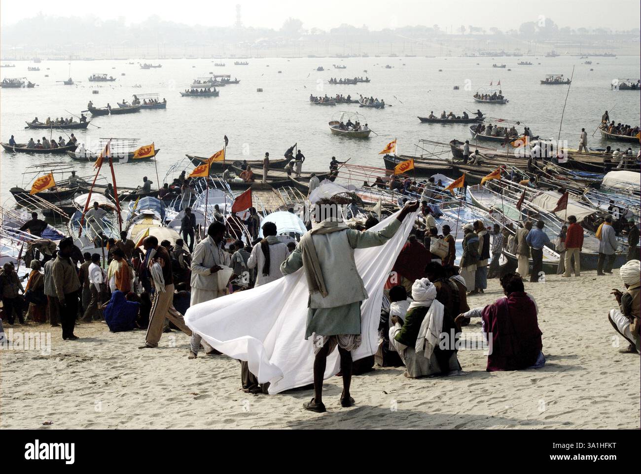 Pilgrims or devotees gather to take boat rides during the Ardh Kumbh ...