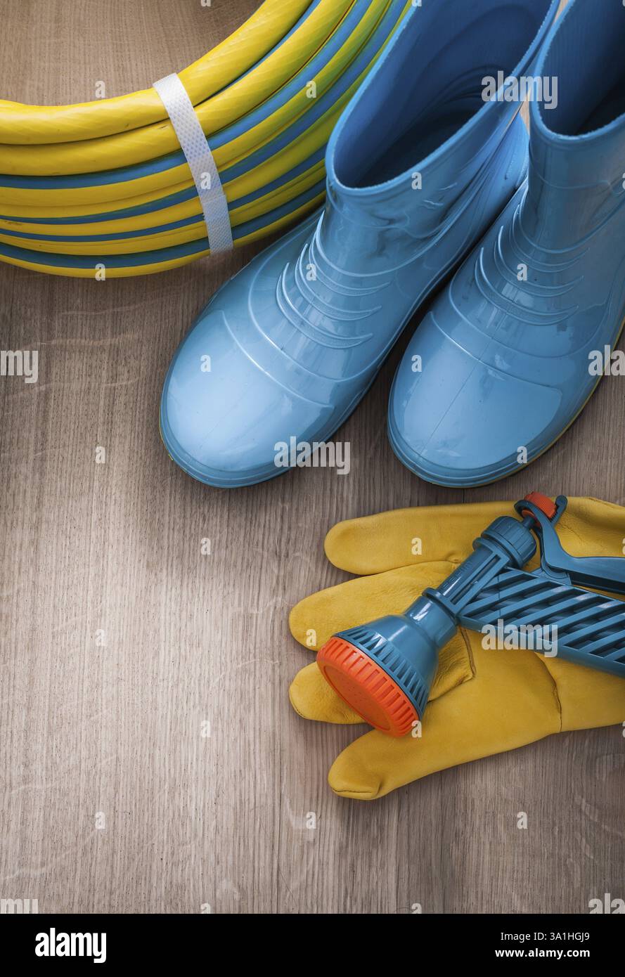 Hand spraying garden hose with spray nozzle leather protective gloves ...