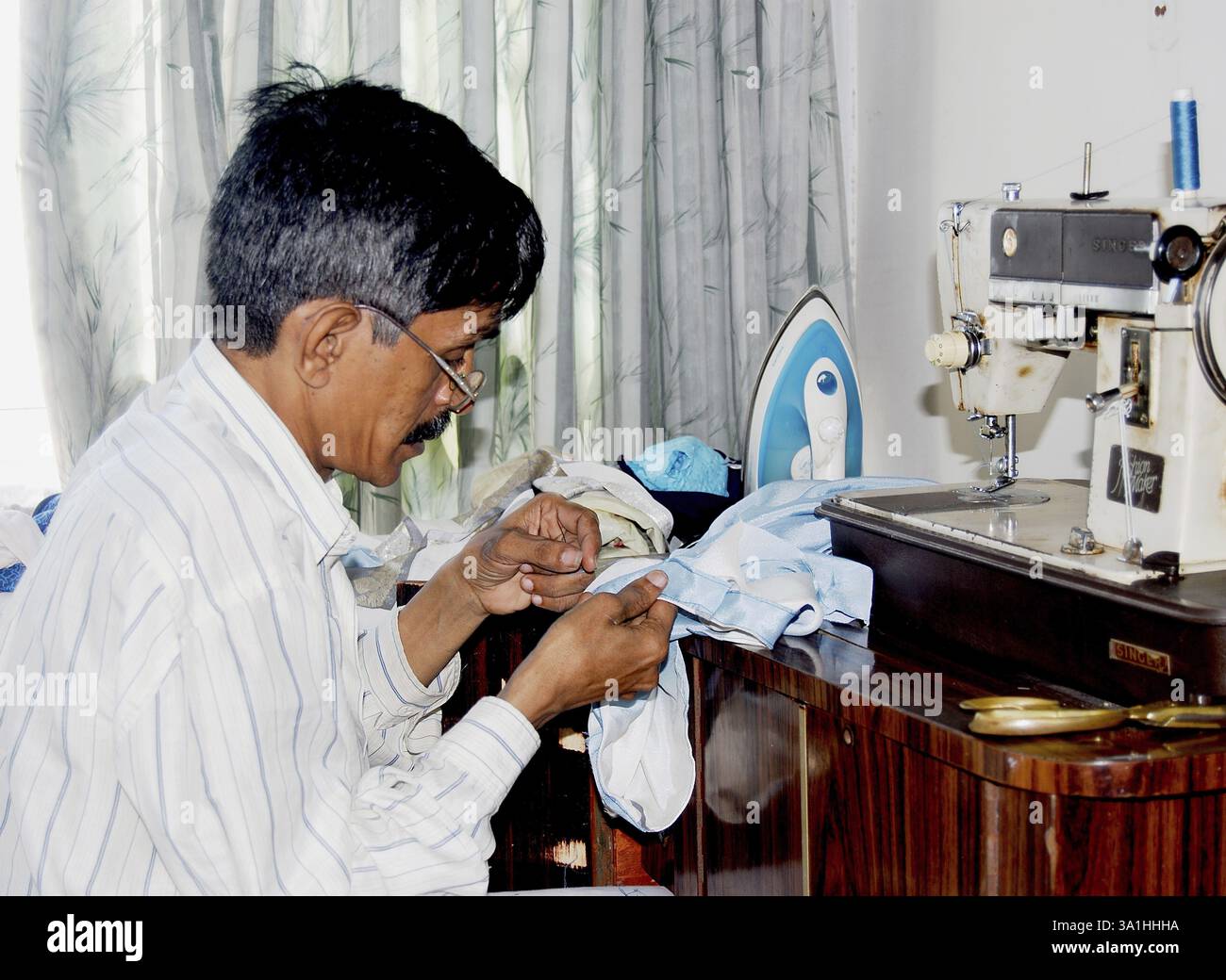 Tailor working on sewing machine, Model released Stock Photo - Alamy