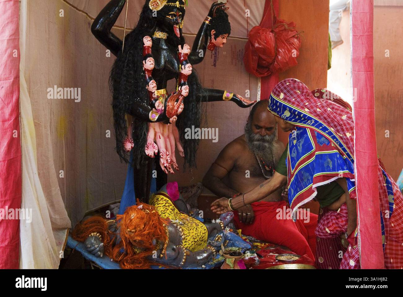 Devotee praying at goddess Kali statue at Hot Springs, Rajgir mela ...