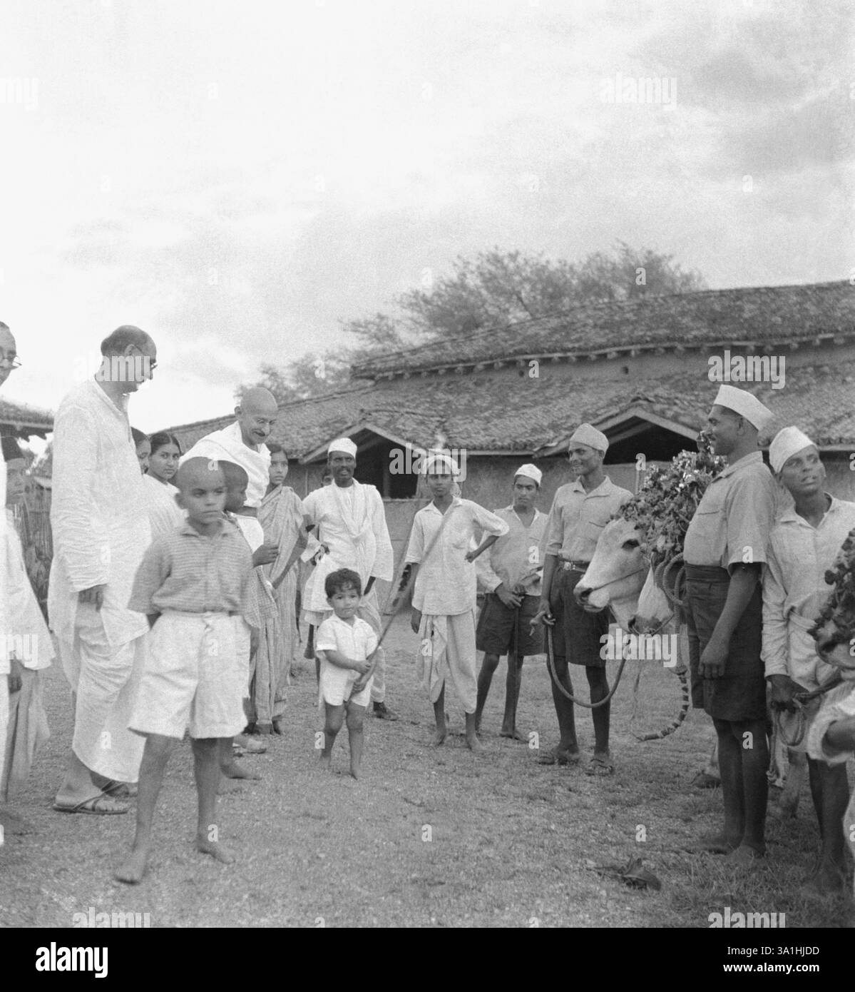 Mahadev Desai, Durga Mehta, Mahatma Gandhi and others at a ceremony ...