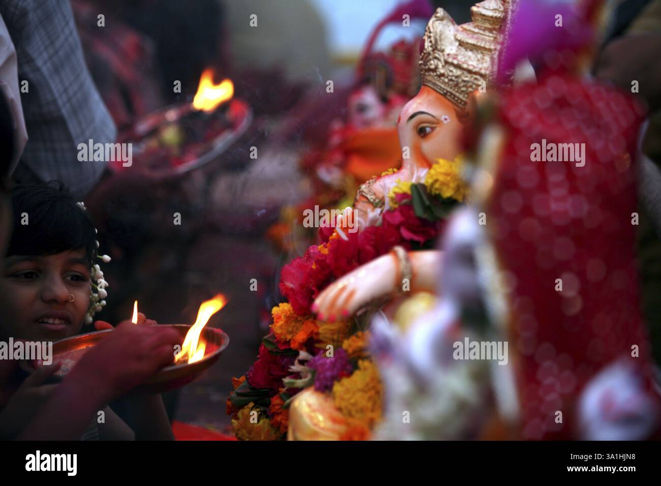 Devotees performing puja of Lord Ganesha ganpati Hindu deity before ...
