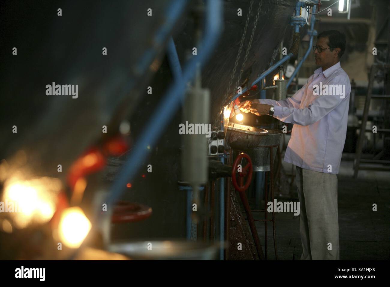 A sugar factory laboratory in charge testing the sugar crystals at the ...