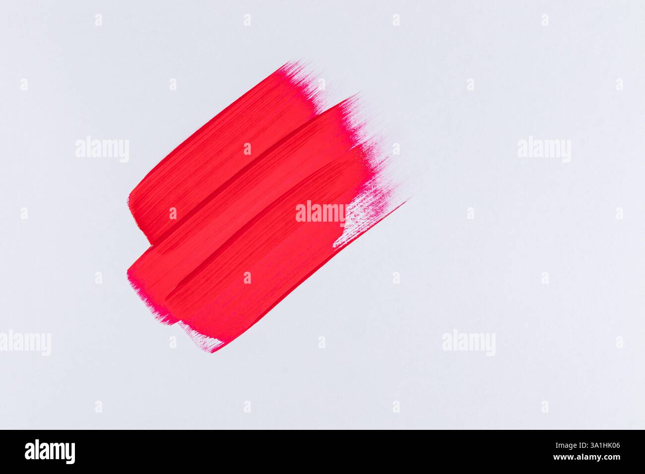 Three parallel strokes with red acrylic paint on a white background ...
