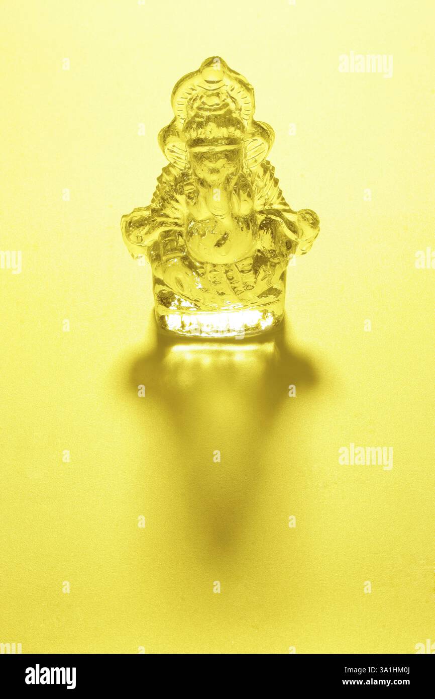 Crystal glass idol of lord Ganesh elephant headed god with shadow on ...
