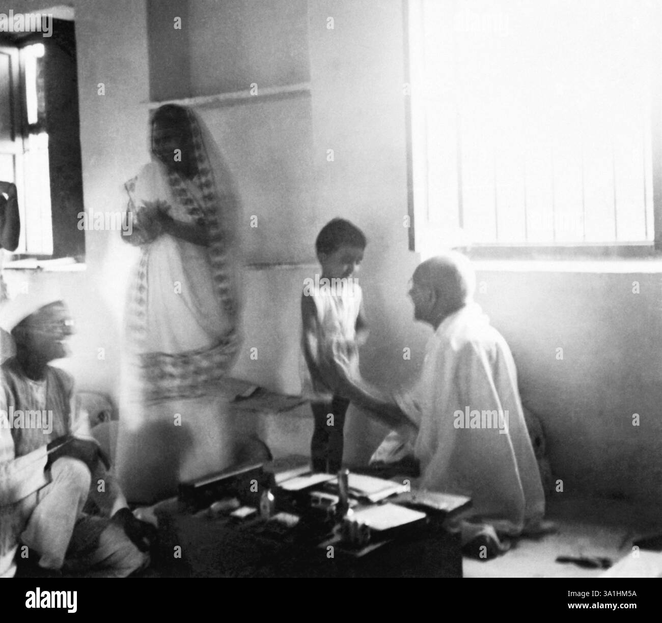 Mahatma Gandhi playing with a child at Bhangi Colony in Delhi, 1946 ...