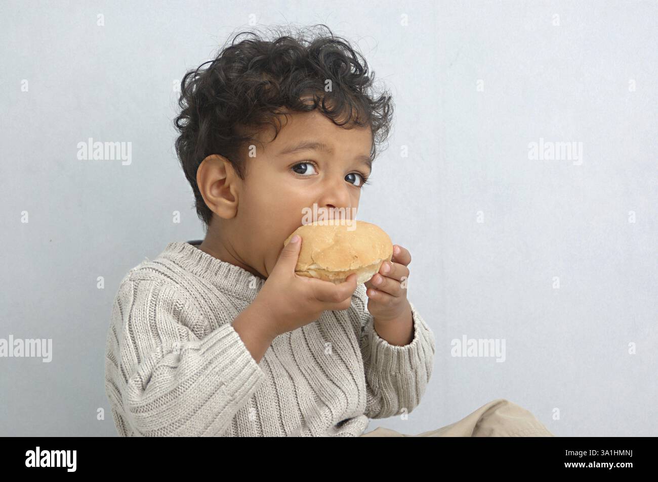 Small Indian boy of two and half years eating cheese sandwich, Model ...