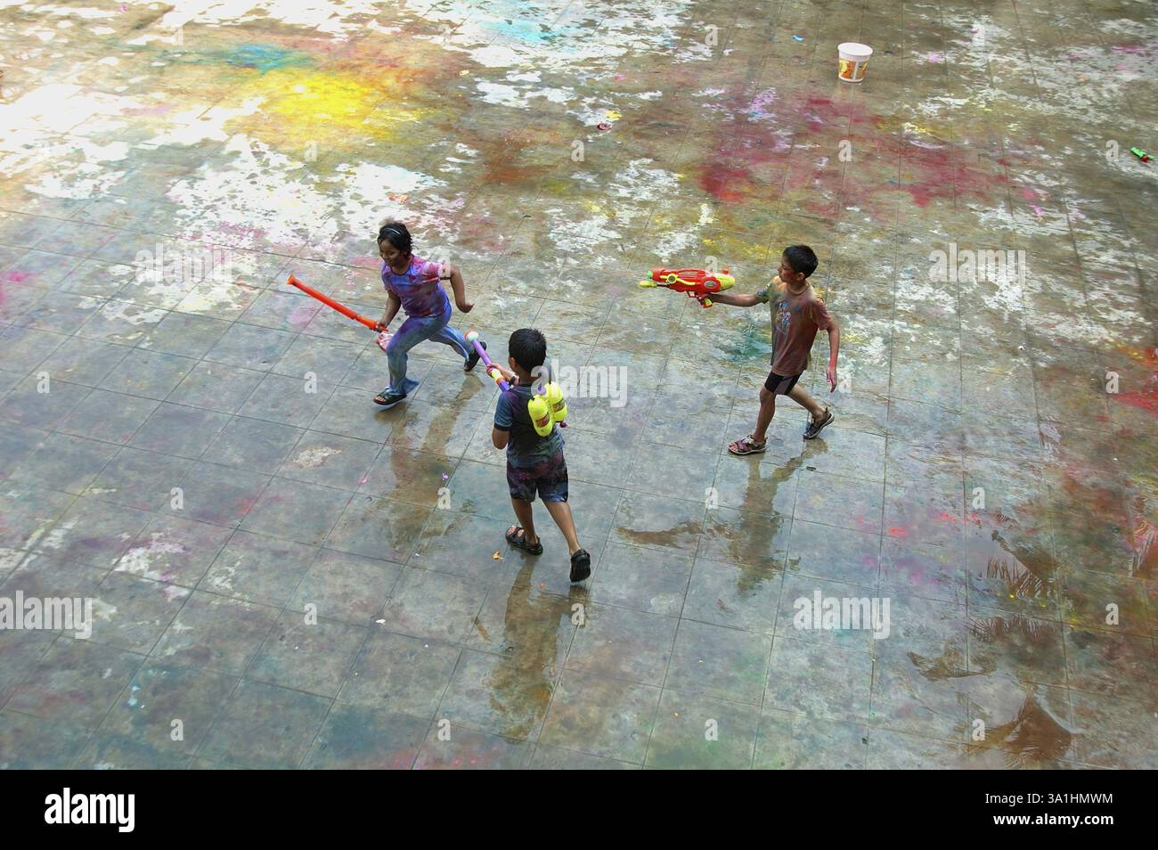 Three children playing Holi festival of color at Ananta apartments at ...