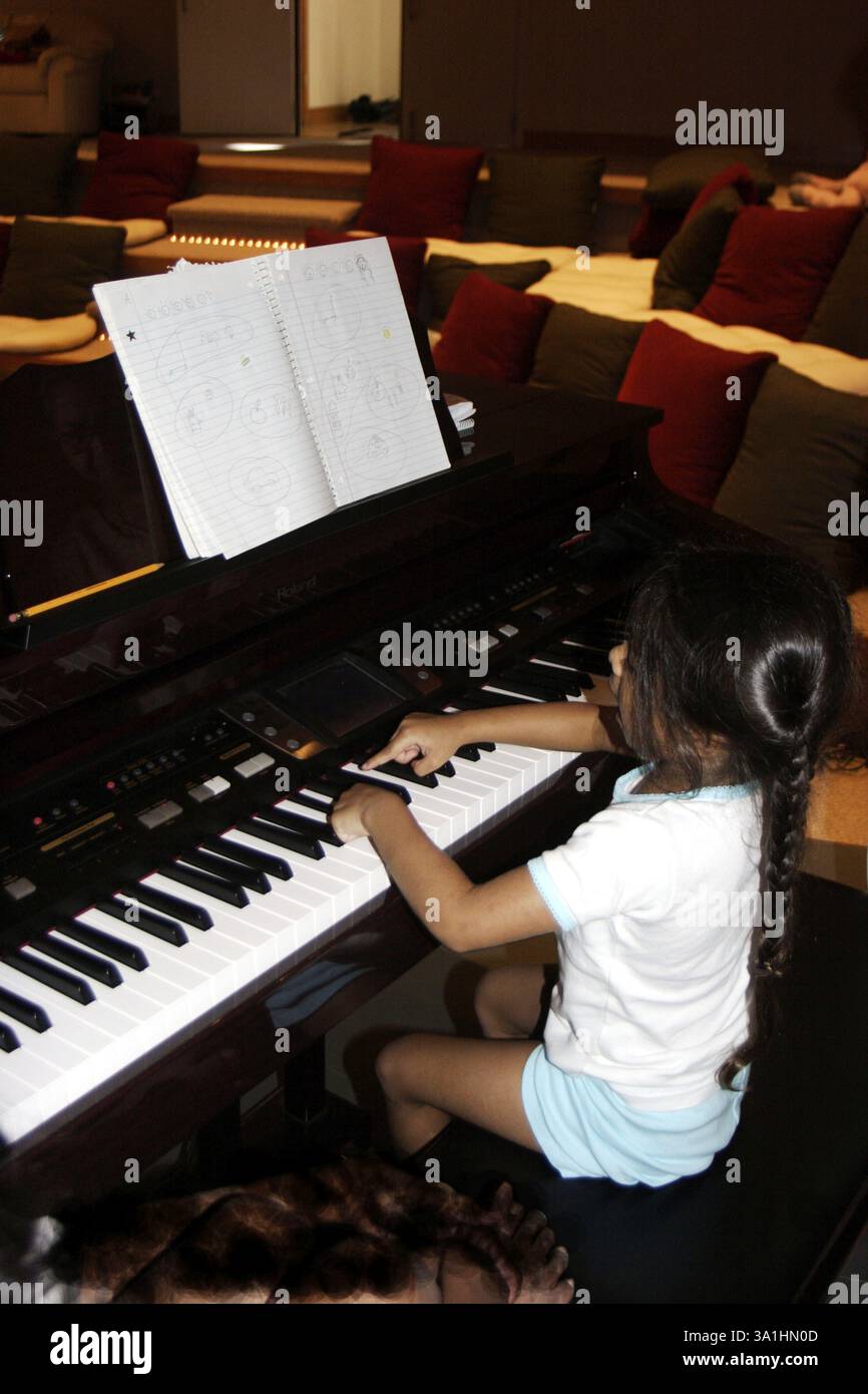 Girl practicing piano lesson Stock Photo - Alamy