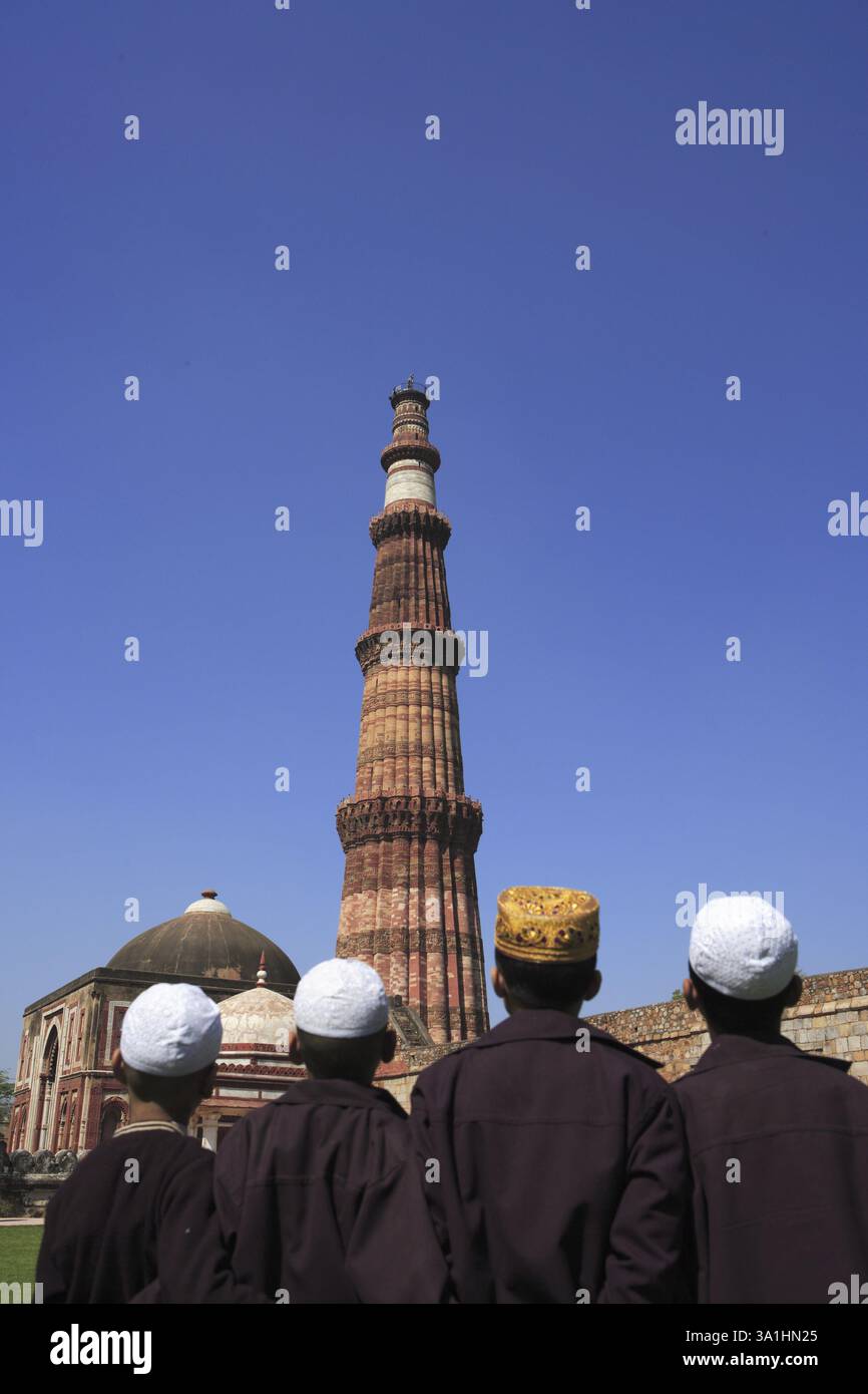 Children doing religious prayer Namaz in front of Qutab Minar built in ...