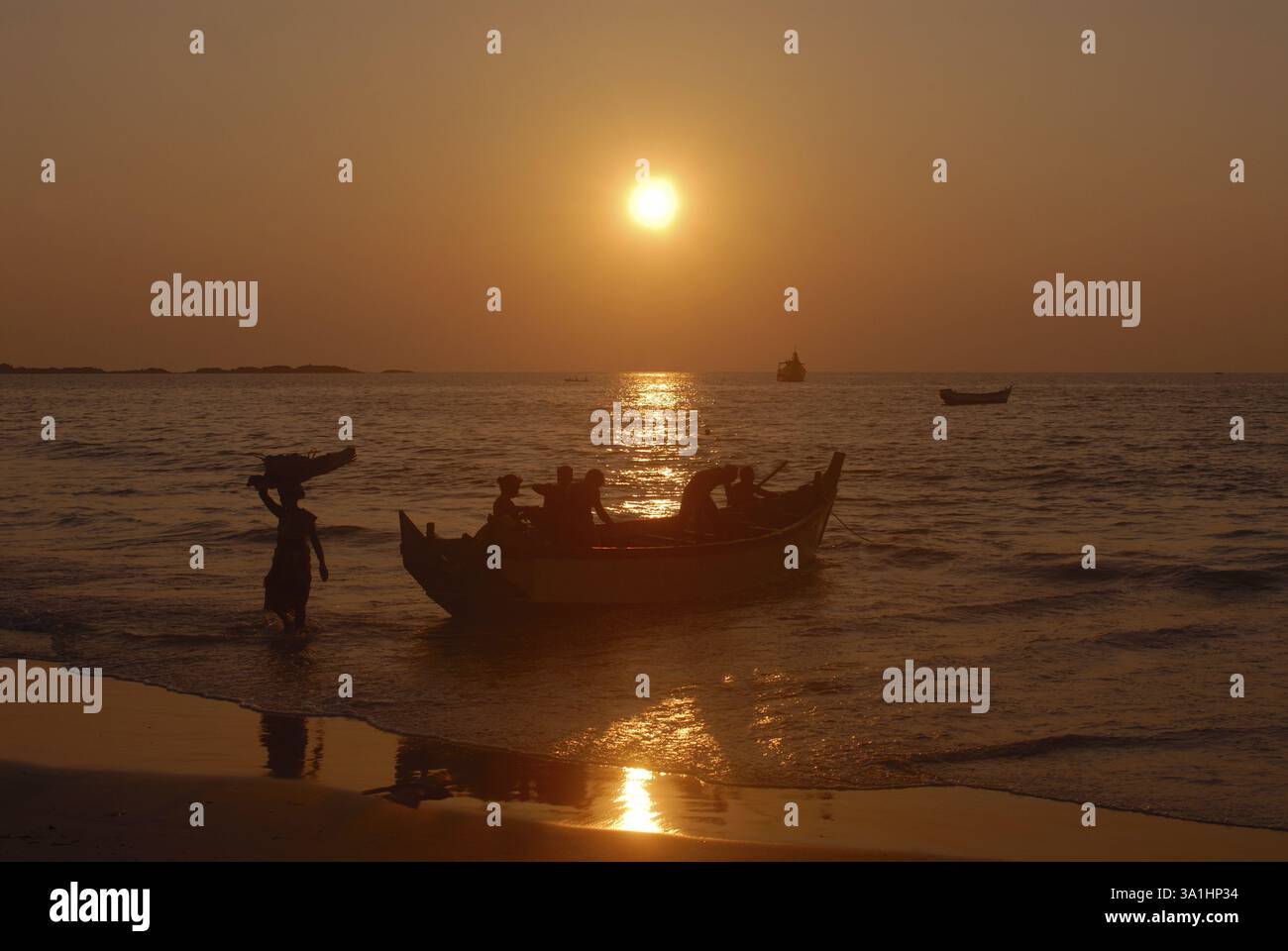 Colorful Sunset with country fishing boat and fishermen unloading fish ...