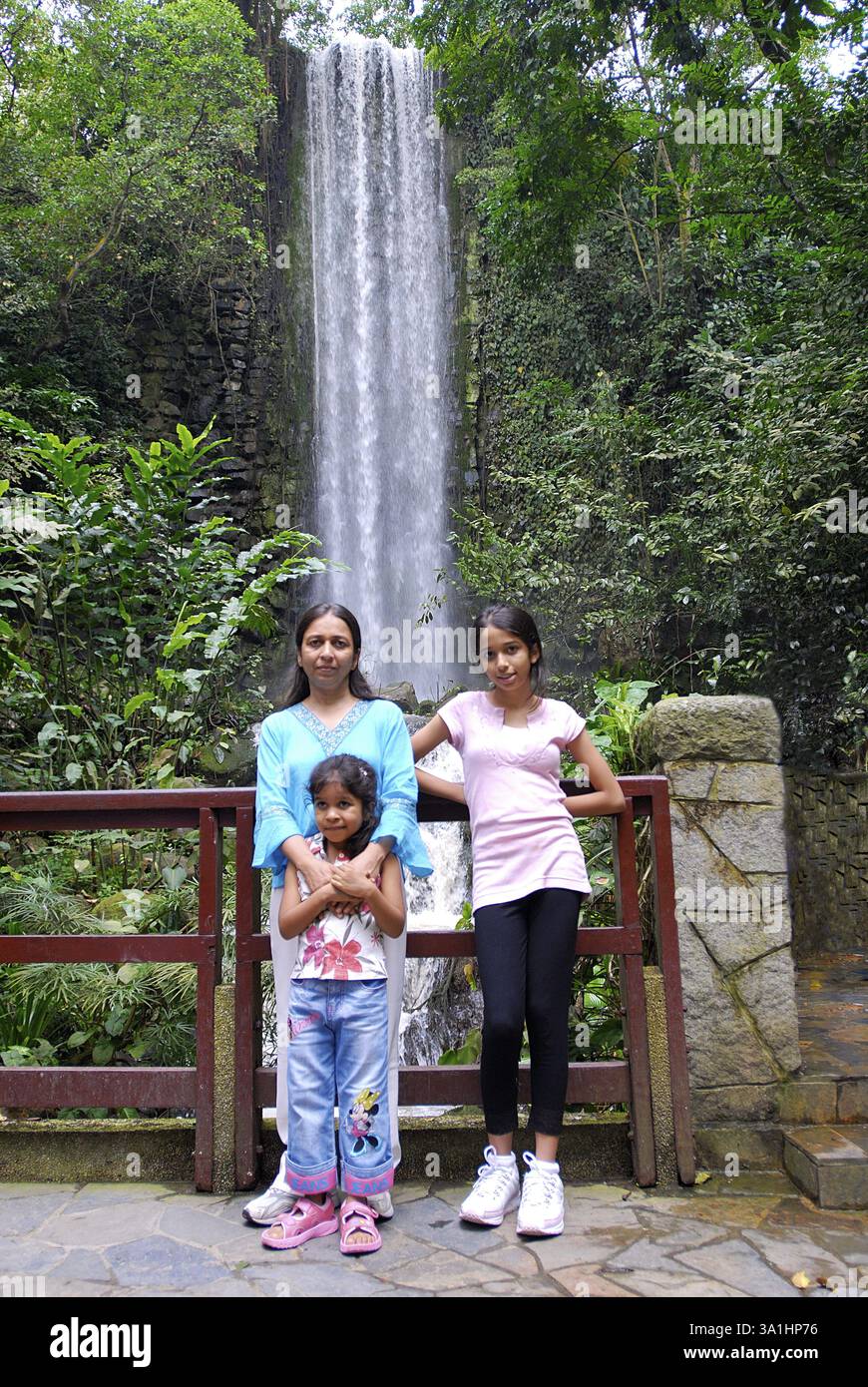 Mother and daughters portrait in front of waterfall at Jurong bird park ...