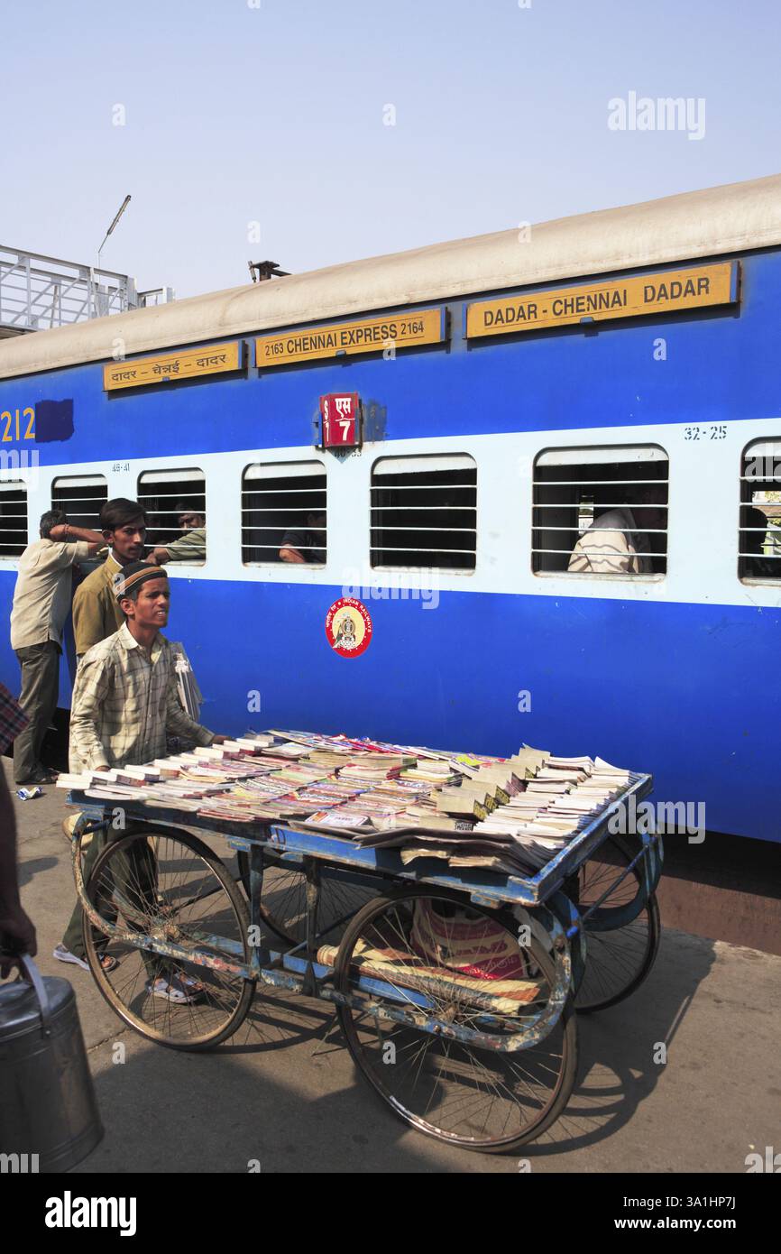 Booker seller with cart at Indian railway on platform, train Name ...