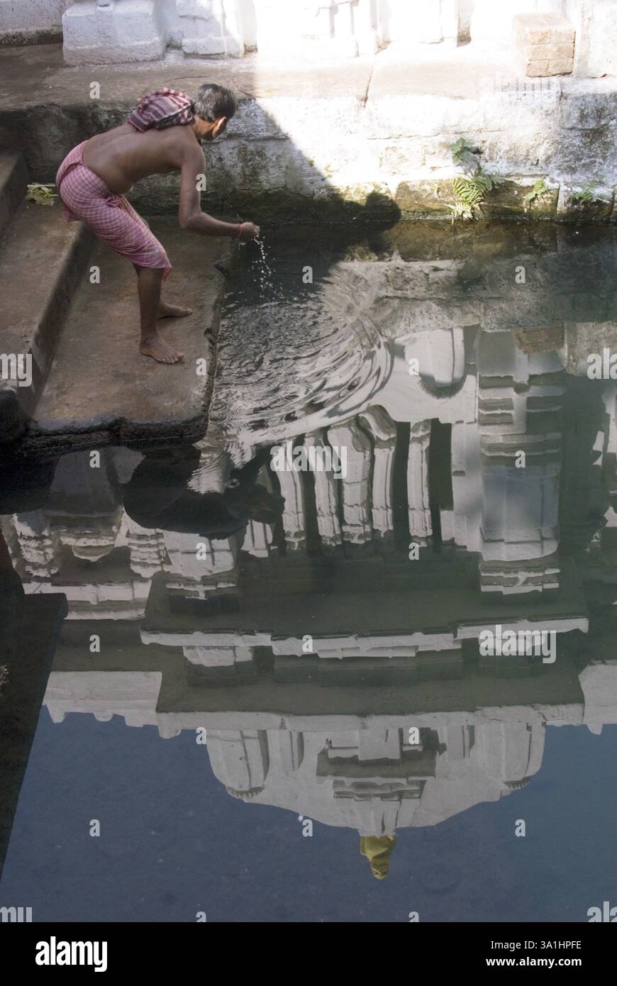 Reflection of 11th century Brahmeshwar temple in ritual pond dedicated to lord Shiva considered ...