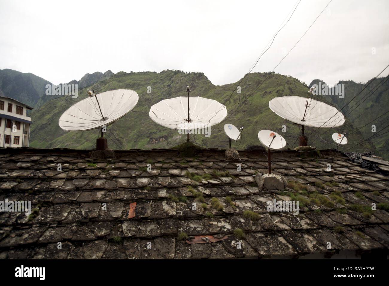 Disk antenna over the roof top of the houses in Joshimath, Uttaranchal ...