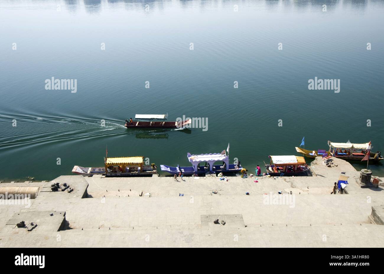 Boats at Maheshwar ghat at bank of river Narmada, Madhya Pradesh, India ...