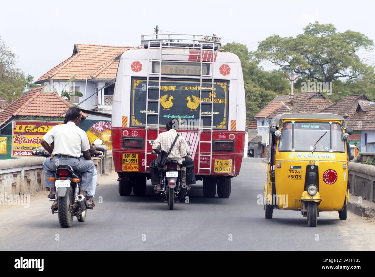 Heavy traffic on narrow bridge on river Pazhayar and village houses ...