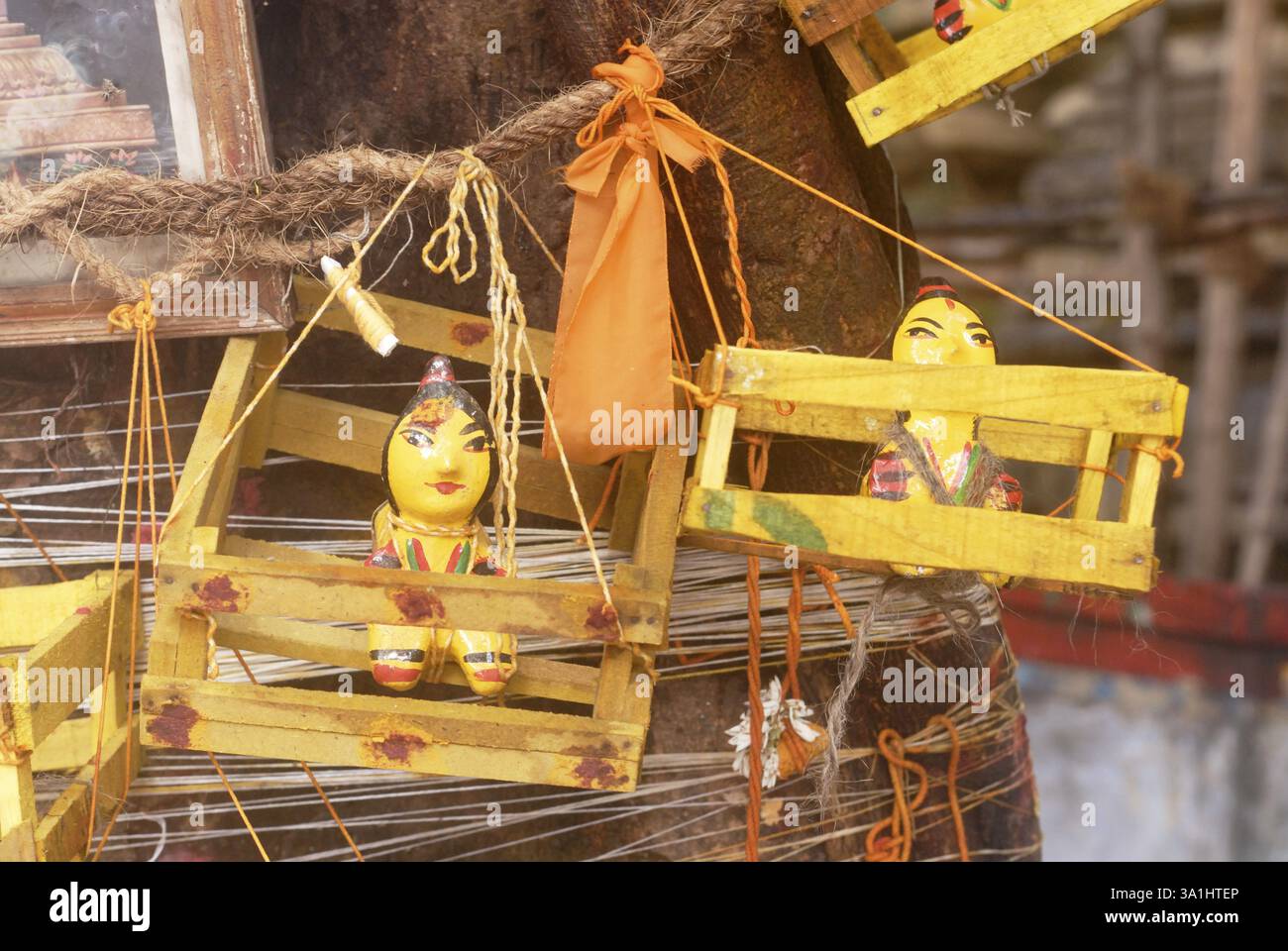 Small symbolic cradles hang to tree trunk, offering of devotees at ...
