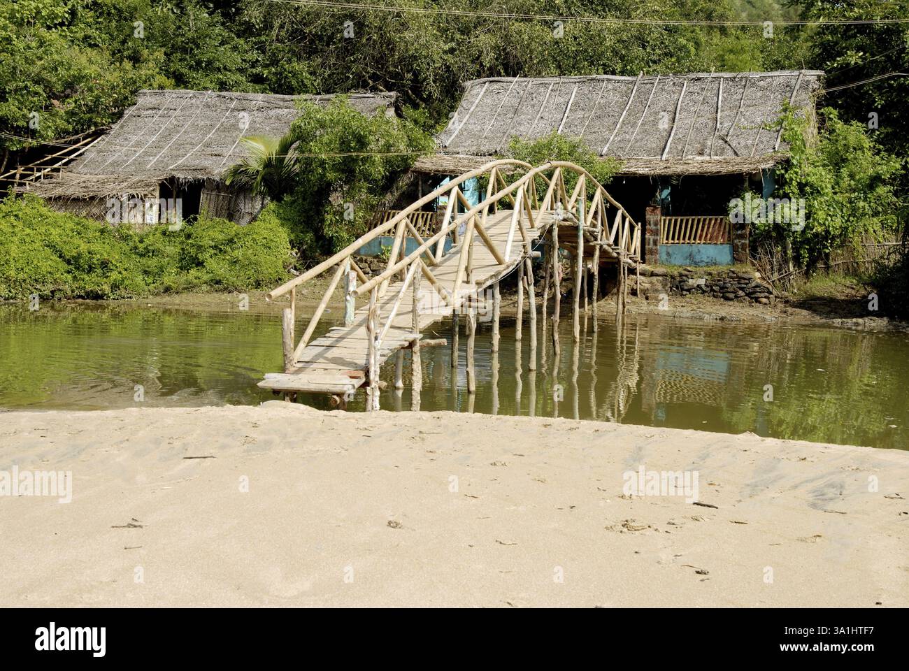 Huts with thatched roof connected by bamboo bridge at Om beach, Kumta, Karnataka, India, Asia ...