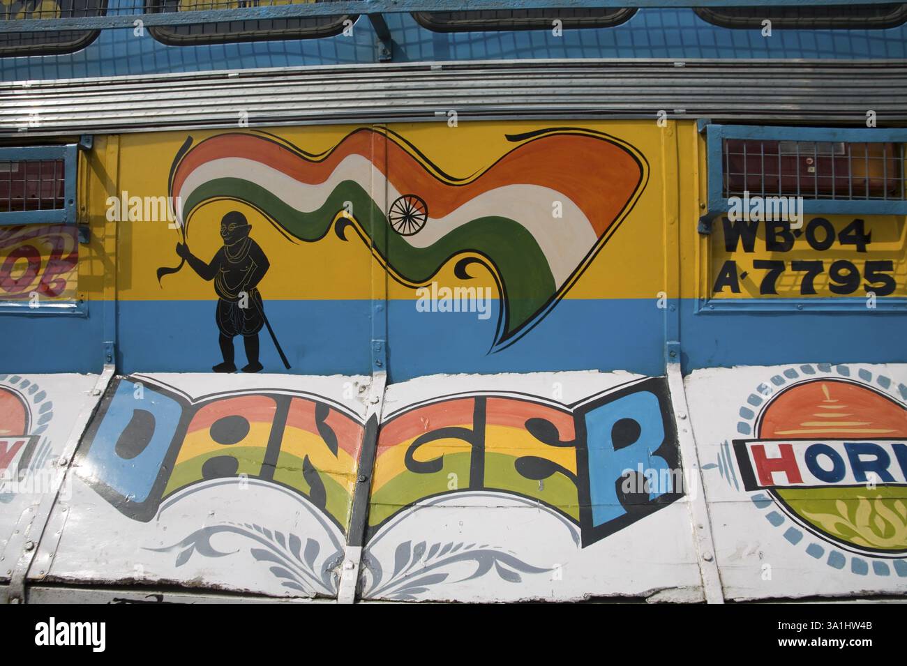 Painted back panel of local bus showing Gandhi carrying Indian national ...
