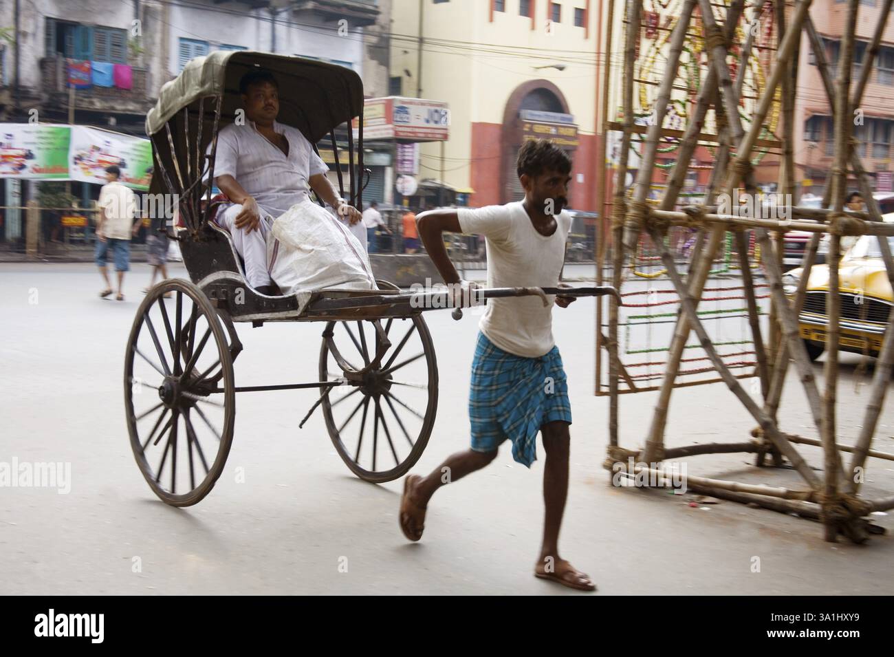 Man pulling hand rickshaw with passenger street scene in Calcutta now ...