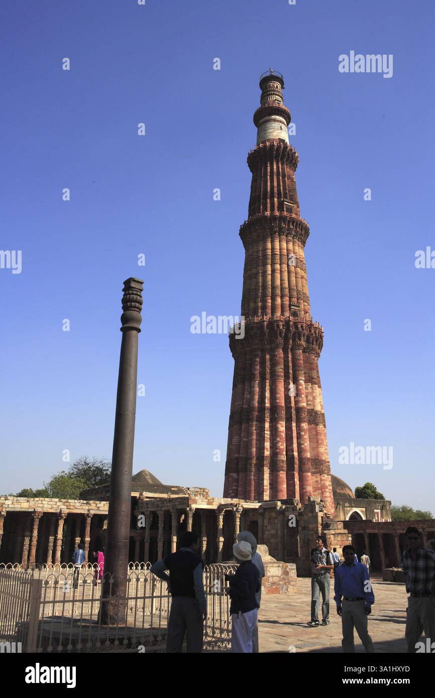 Iron pillar in Quwwat-ul-Islam mosque and Qutb Minar built in 1311 red ...