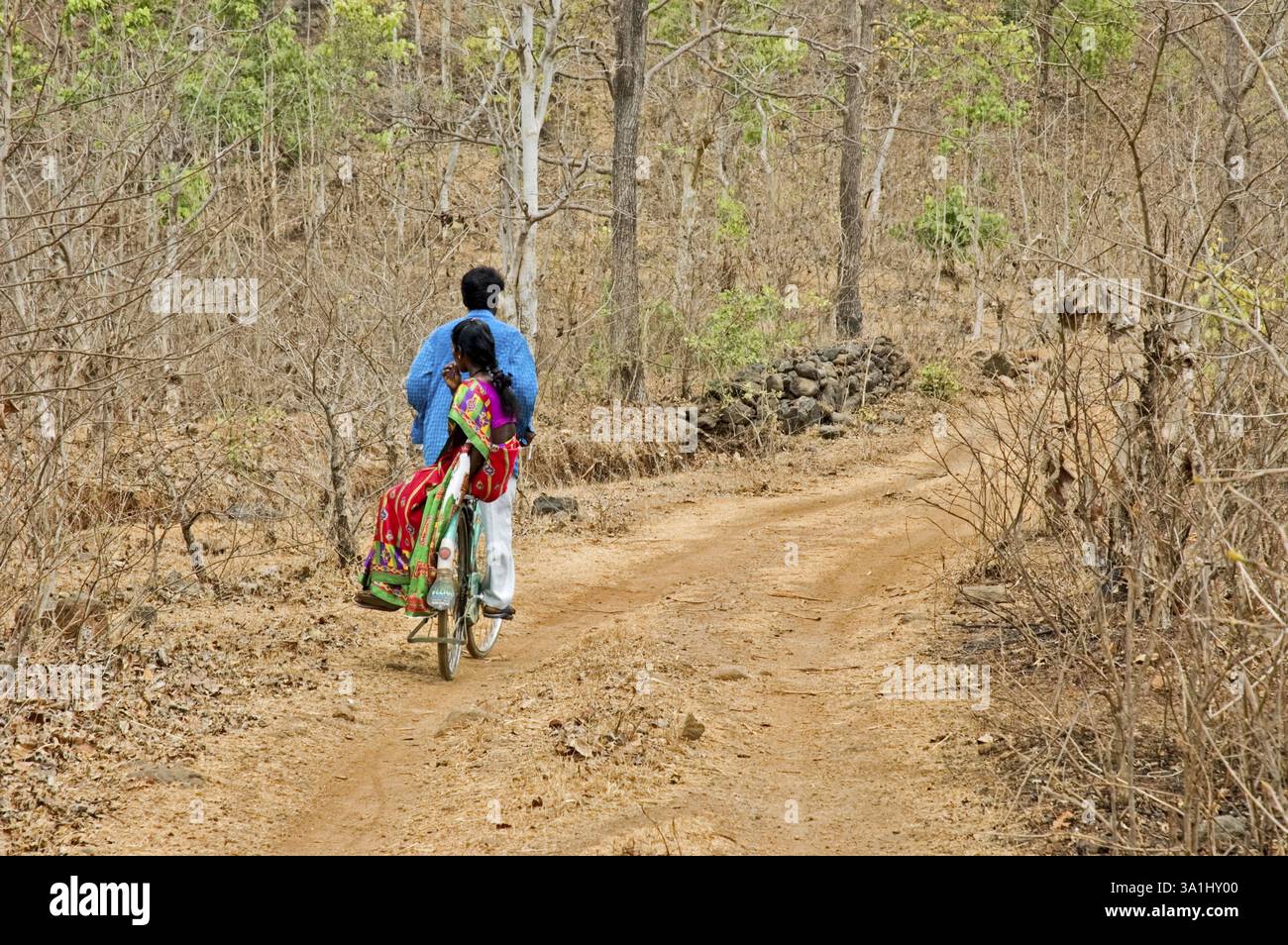 Tribal couple riding bicycle on their way of home cheapest mode of ...