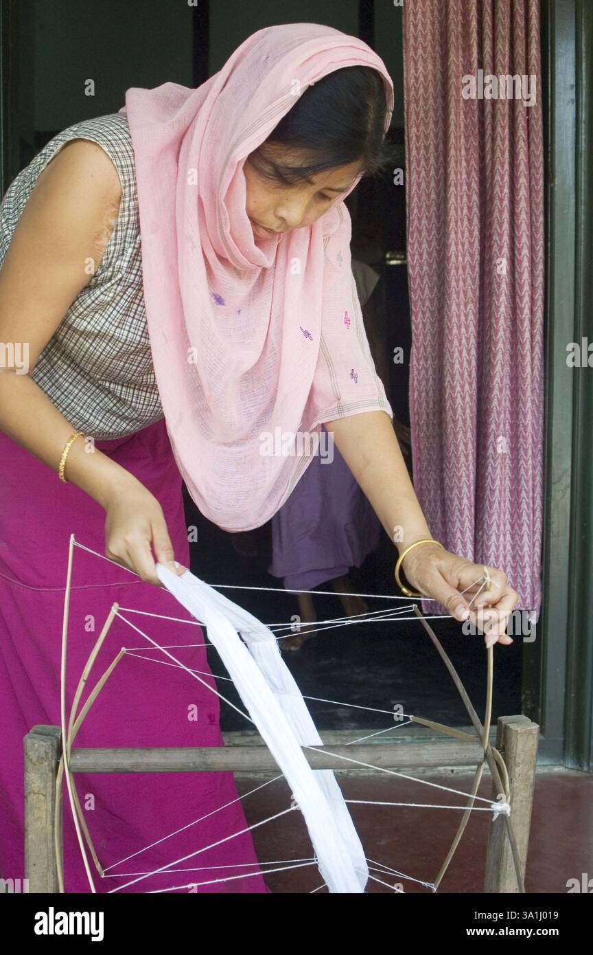 Tribal woman weaving on spinning wheel or charka, Meiteis, Imphal ...