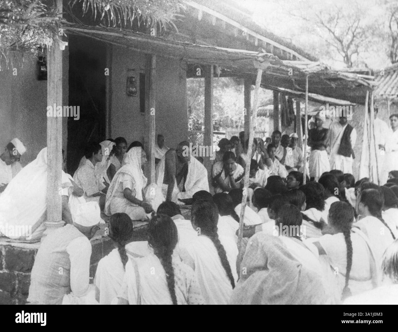 Kasturba Gandhi and Mahatma Gandhi sitting with girls of Mahila Ashram ...