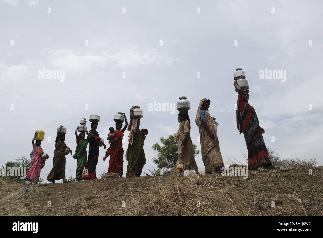 Rural women carrying water pots, water scarcity and migration in ...